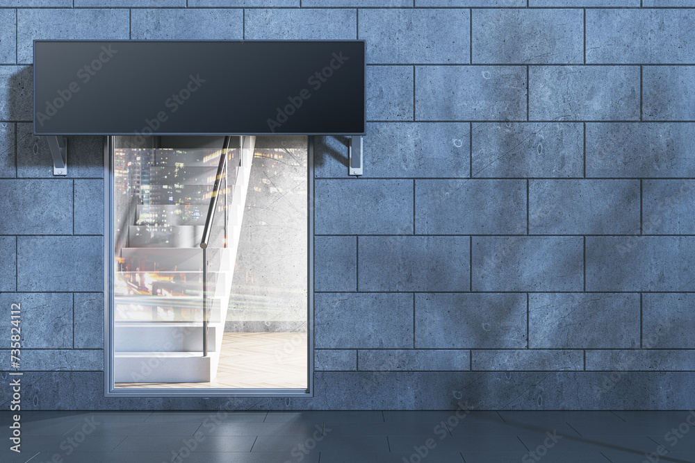 Contemporary nighttime glass storefront in concrete tile building with ...