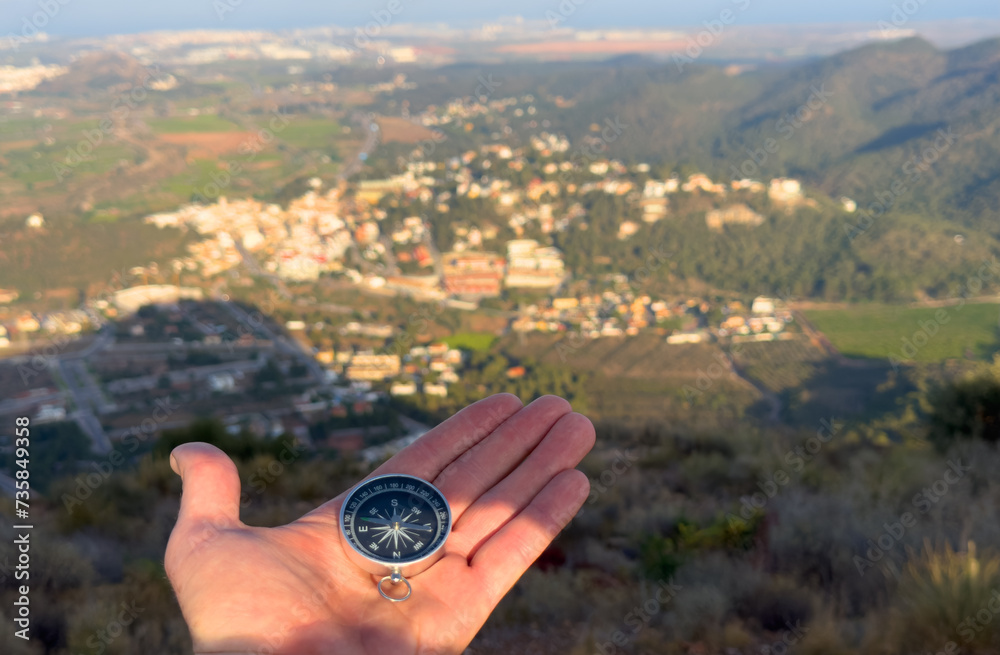 Compass in hand in mountains during Hiking. Tourist compass for ...