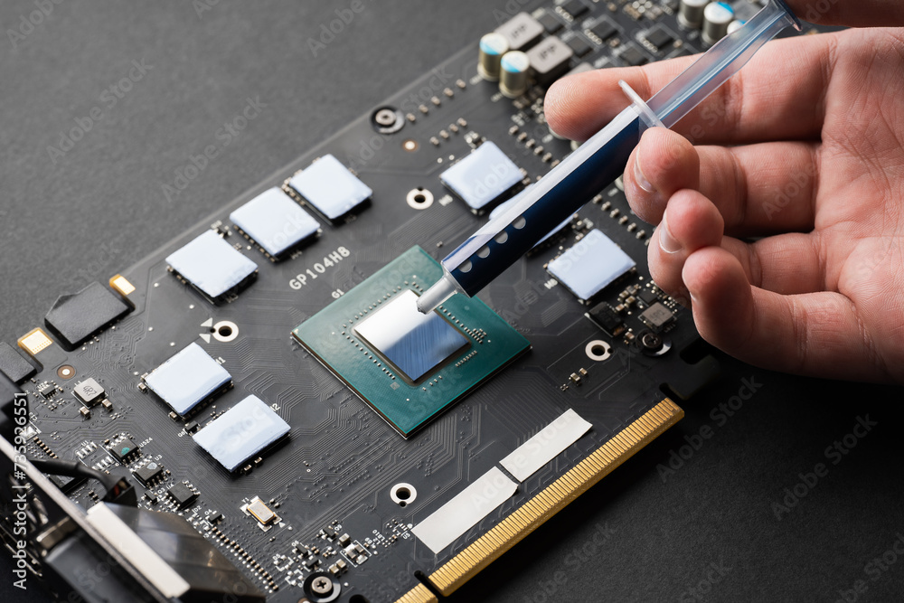 Applying thermal paste to a computer processor. Processor installation concept and cooling ...