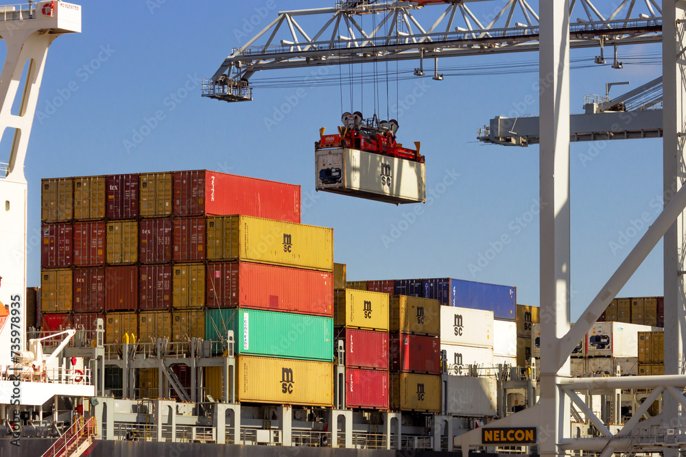 MSC shipping container loaded on a container ship by gantry cranes in ...