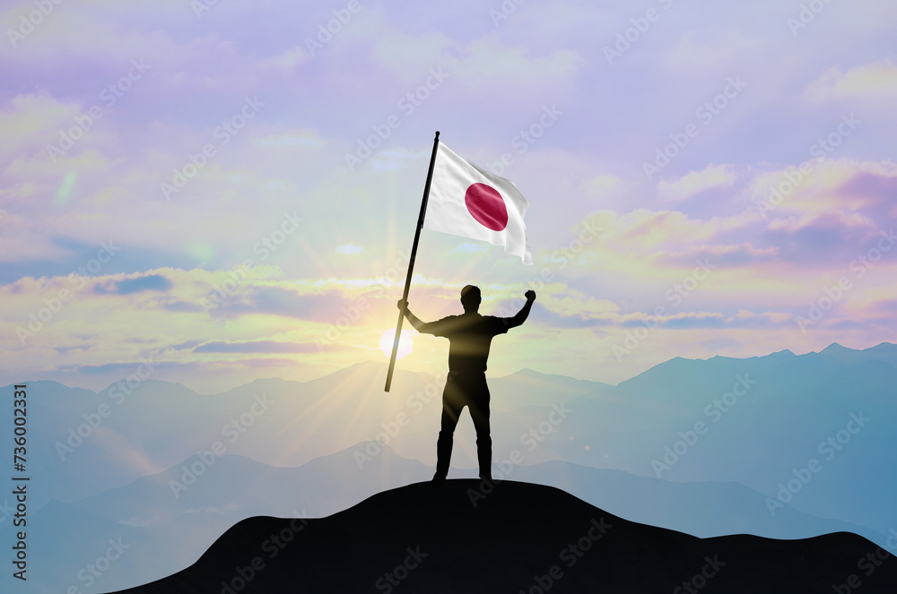 Japan flag being waved by a man celebrating success at the top of a ...