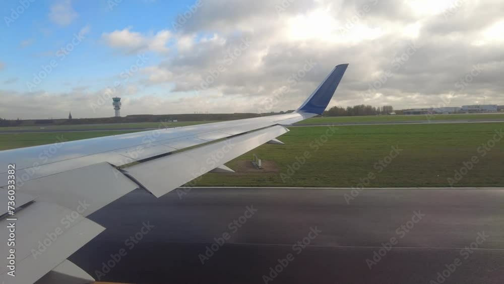 Aircraft window view perspective wing shot taxiway with air traffic ...
