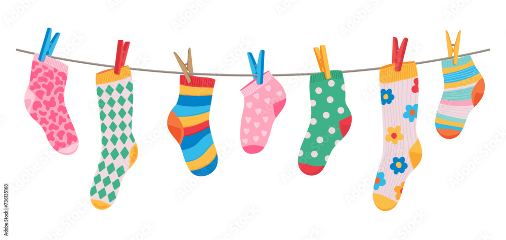 Cotton and wool socks hanging on clothesline rope with clothespins ...