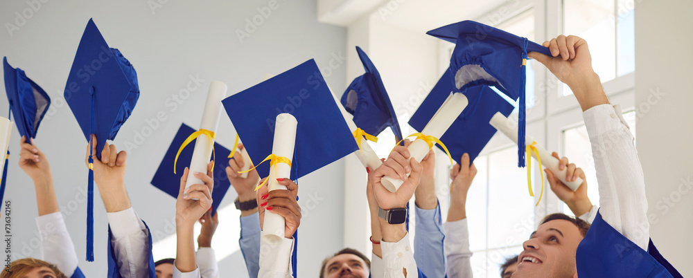 Cropped photo of a group of smiling graduates students standing indoors ...
