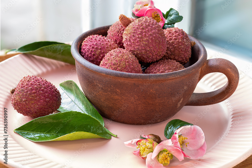 Lychee fruits in rustic ceramic teacup. Litchi Sonn. Flowers of ...