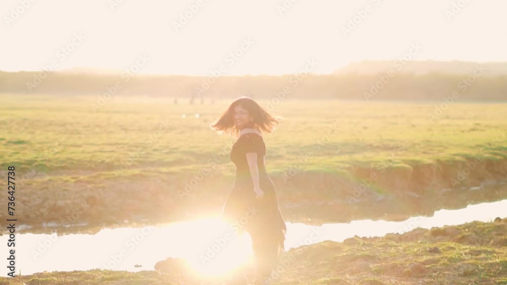 Beautiful Indian teenager girl twirling while standing on grass field ...