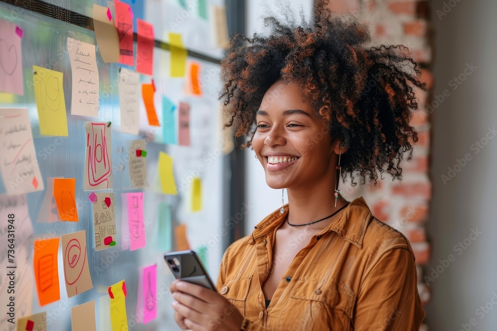 A cheerful woman's handwritten notes adorn the wall behind her as she ...