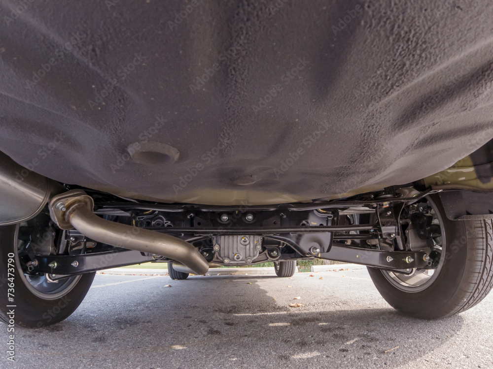 Auto mechanic view of bottom of the car. Rear differential axle wide ...