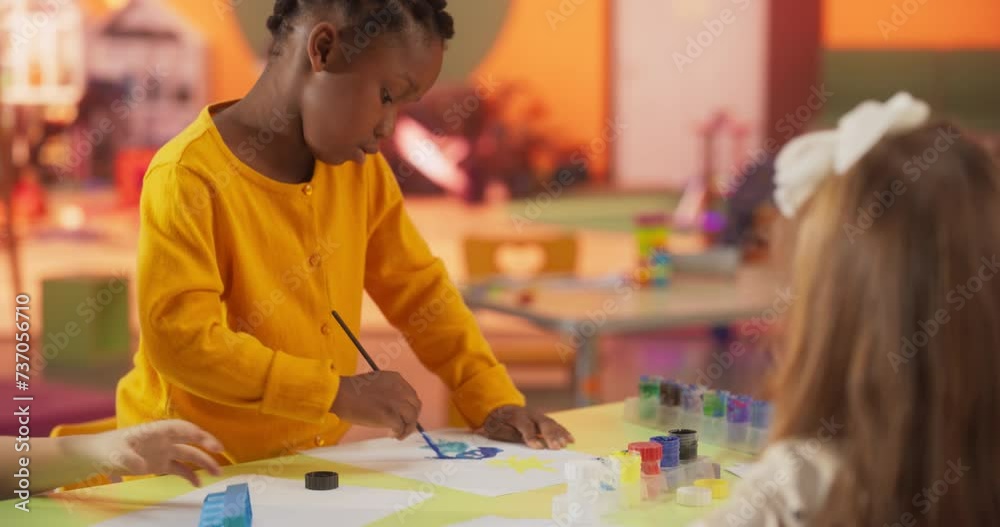 Talented African American Girl Sitting Behind a Desk and Painting with ...