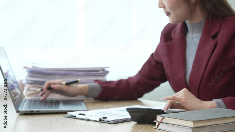 young Asian businesswoman in formal suit conducting annual audit ...