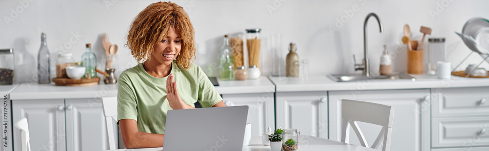 happy african american woman in braces using sign language during video ...