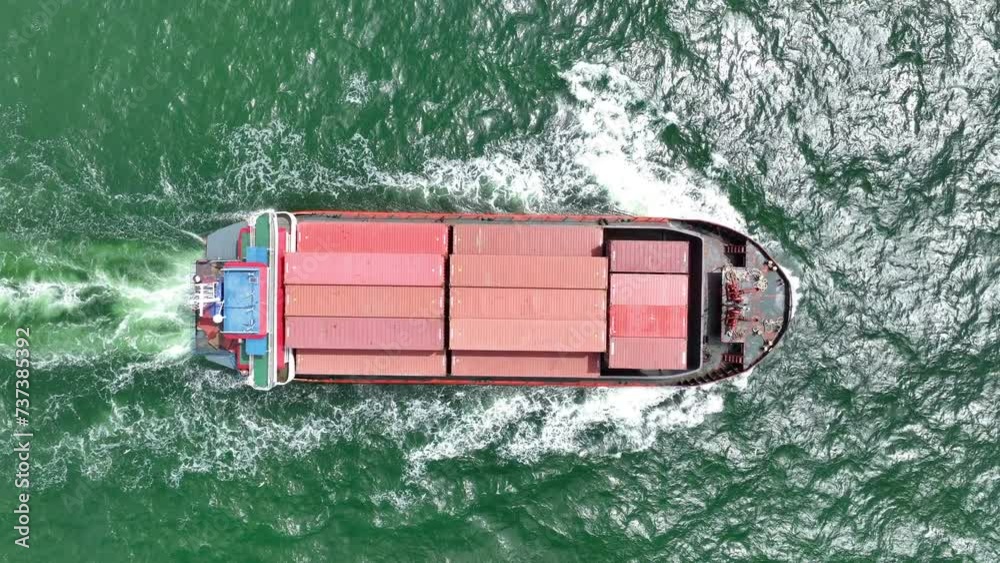 Aerial top view of a little small cargo ship carrying container and ...