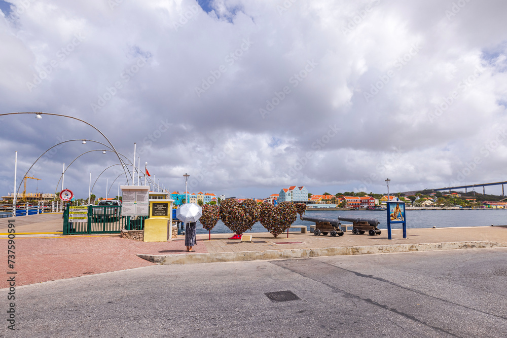 View of landmarks along st. Anna Bay waterfront with Queen Emma Bridge ...