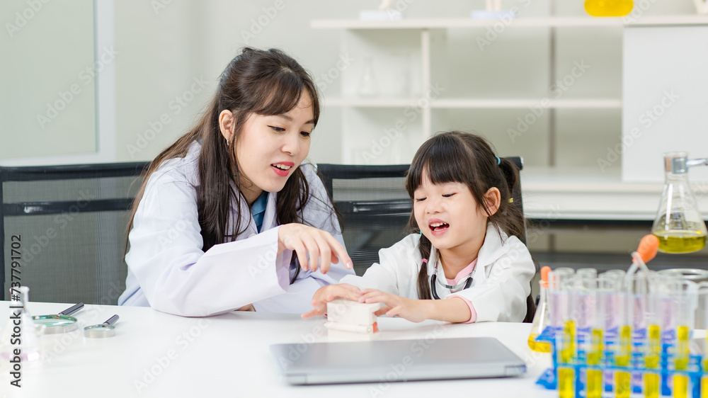 Asian woman doctor physiotherapist explains human fake skeleton teeth ...