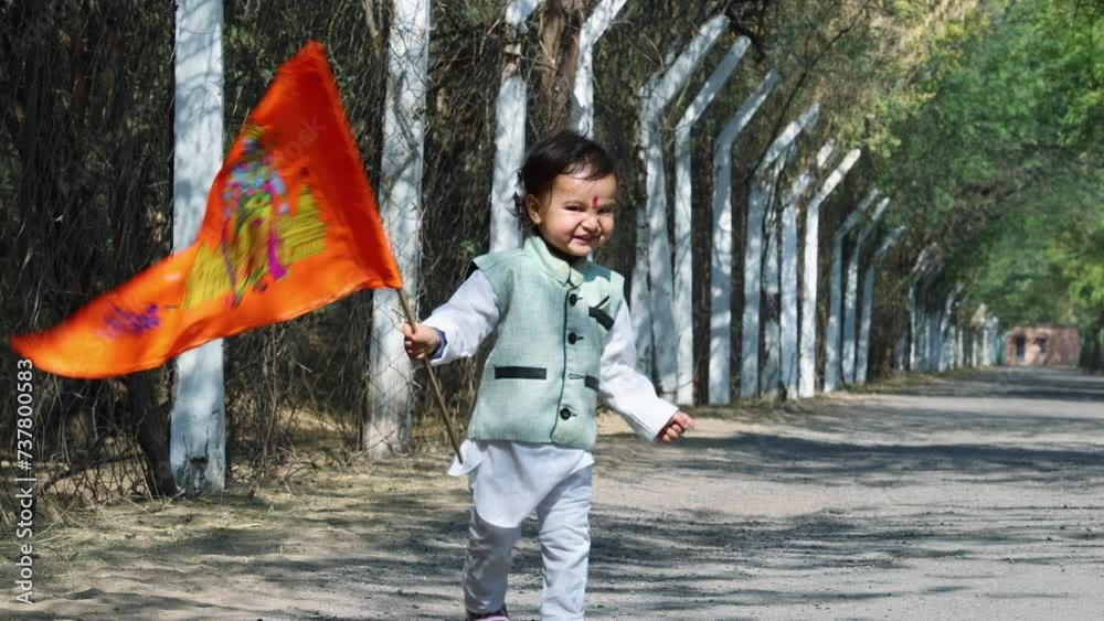kid walking holy saffron flag with lord rama idol at day from flat ...