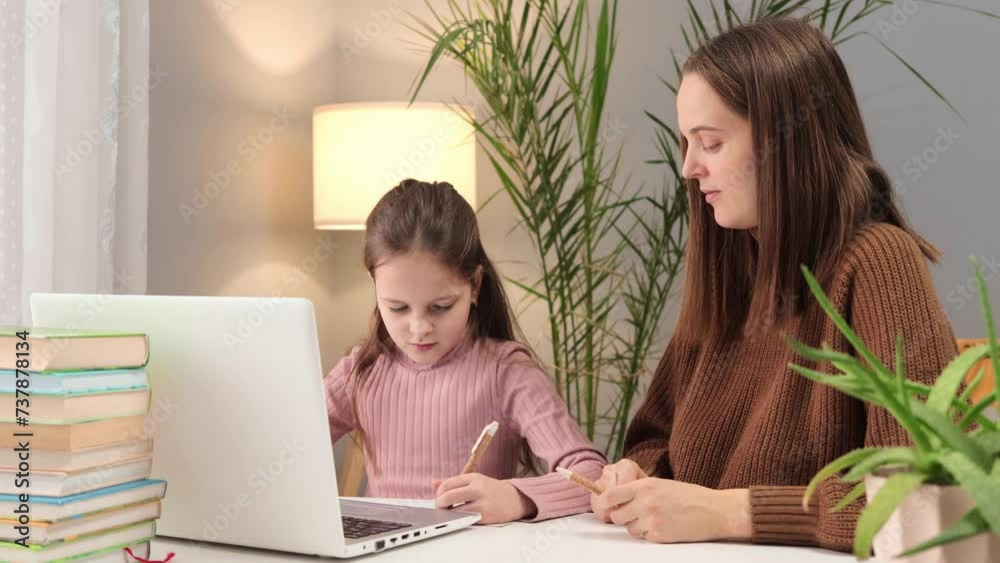 Learning together in online class. Mother as child's study tutor. Home ...