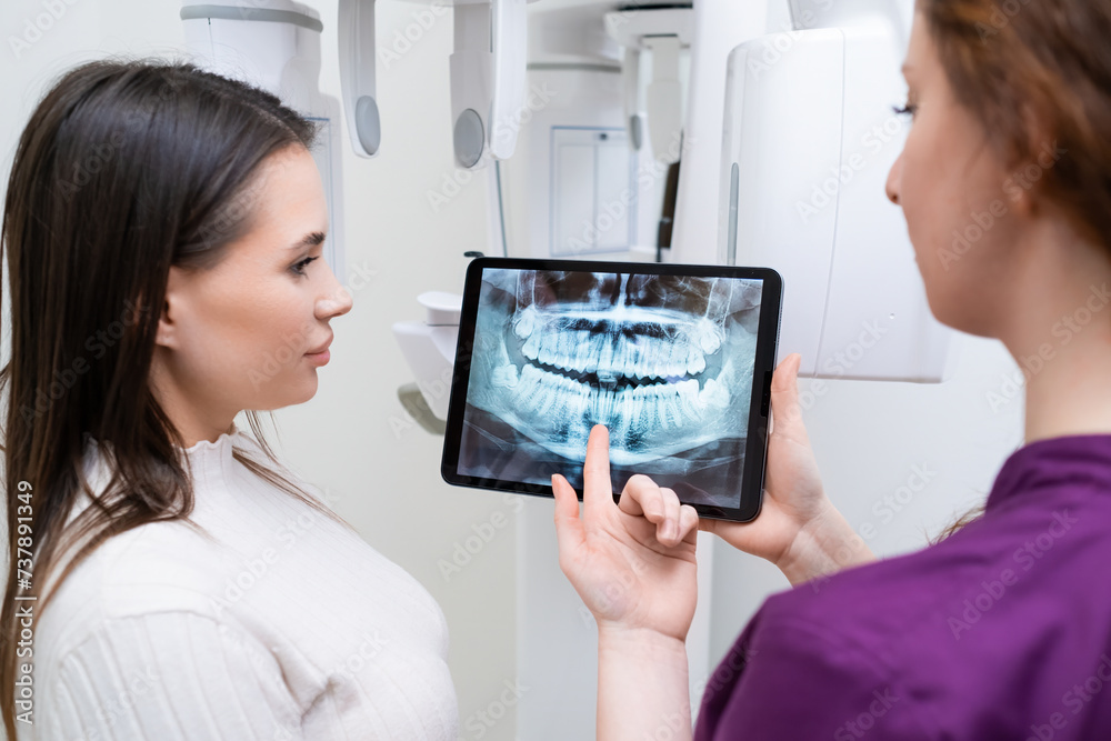 Dentist Presenting Jaw and Teeth Radiograph x ray to Patient in Dental ...