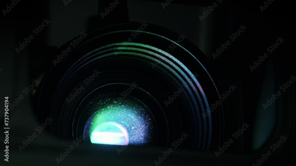 Projector emits multi-colored beams for vibrant display. Close-up lens ...