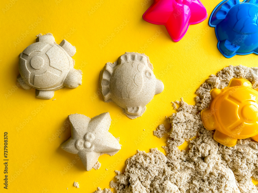 Beige kinetic sand for kids on yellow background, development and play ...