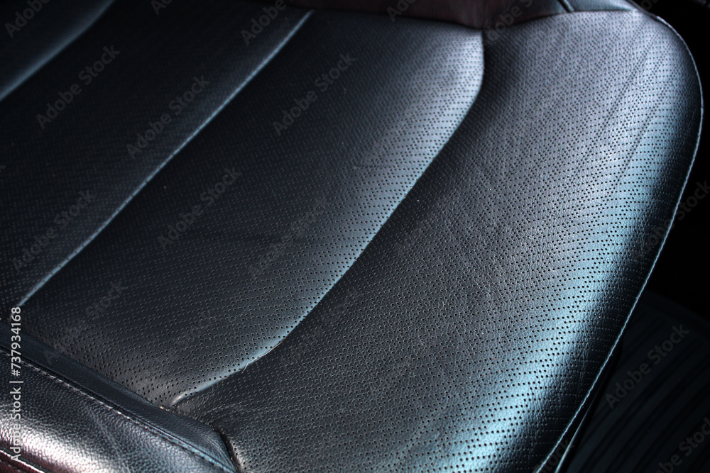 Luxury car interior details. Black leather seat. Perforation of black ...