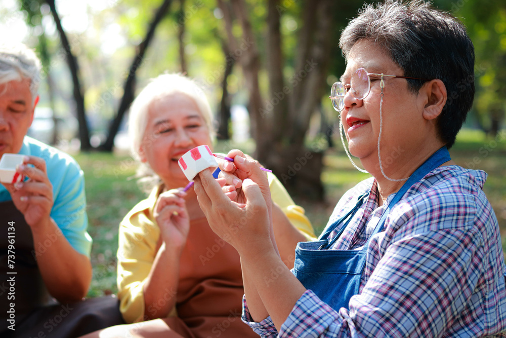 Art activities for the elderly. A group of elderly people sit and paint ...