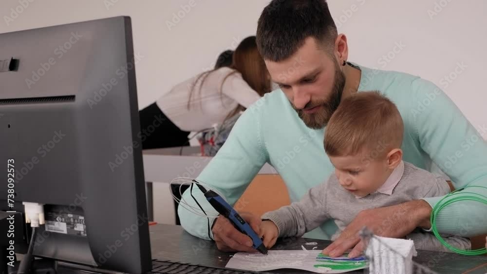 A young father teaches his young son how to make various models using a ...