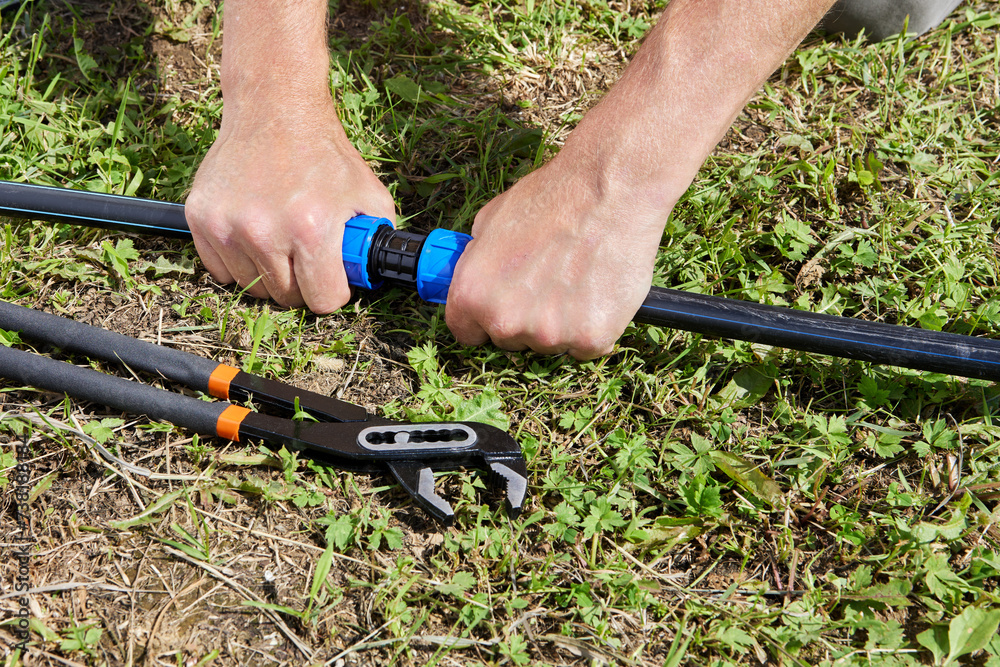 Parts of polyethylene pipe are connected by coupling fitting with a ...