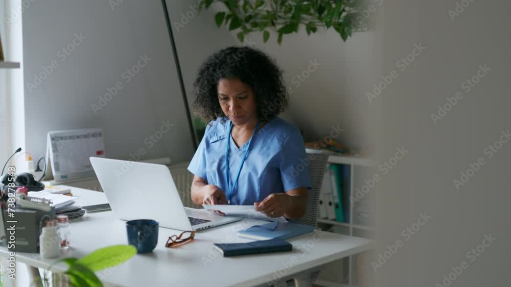 Female doctor feeling overwhelmed at work, sitting at table, reading ...