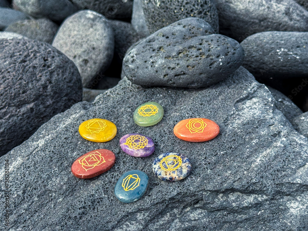 Healing crystals, chakra stones. Rainbow gemstones in a circle on grey ...