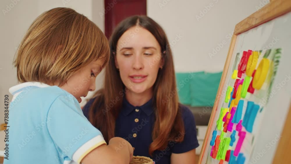 Mother and child engaging in educational play with colorful plastic ...