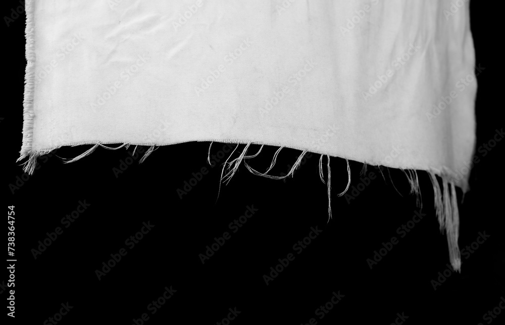 hanging teared rag spread isolated on black background , can use like a ...