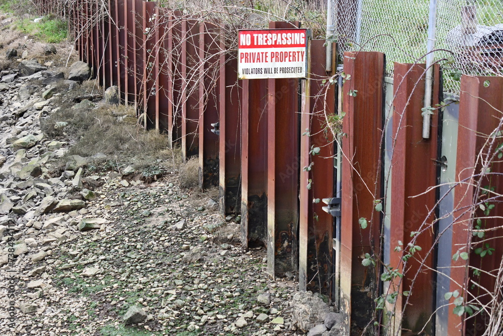 No trespassing sign on steel support beams. Retaining wall. Stock Photo ...