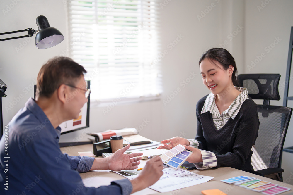 Interior designer women explaining blueprint of construction ...