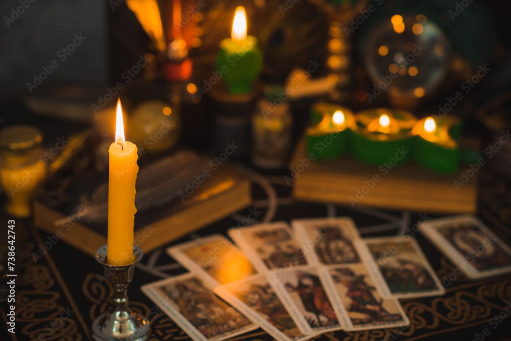 Altar of modern witch. Candles and oracle stuff on a table. Mental work ...