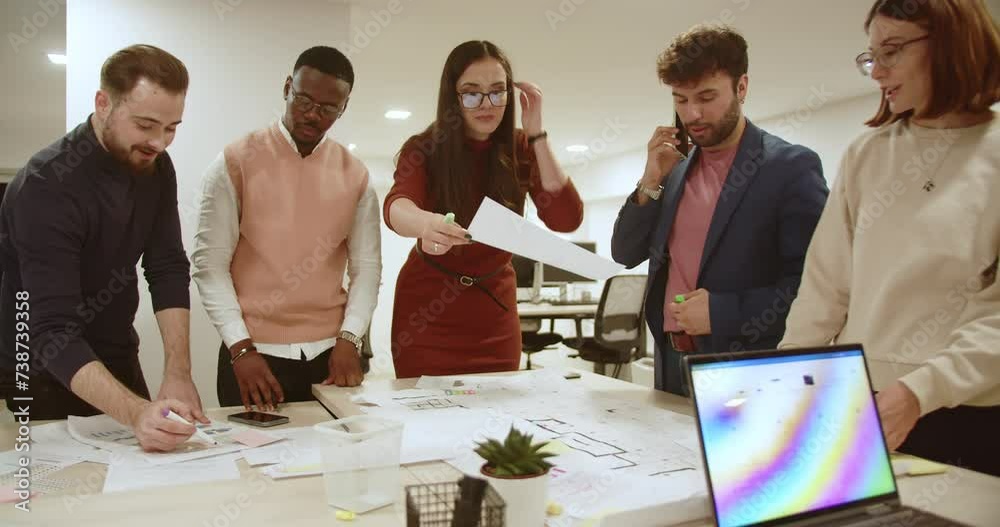 Group of multiracial colleagues focuses on project planning in a well ...