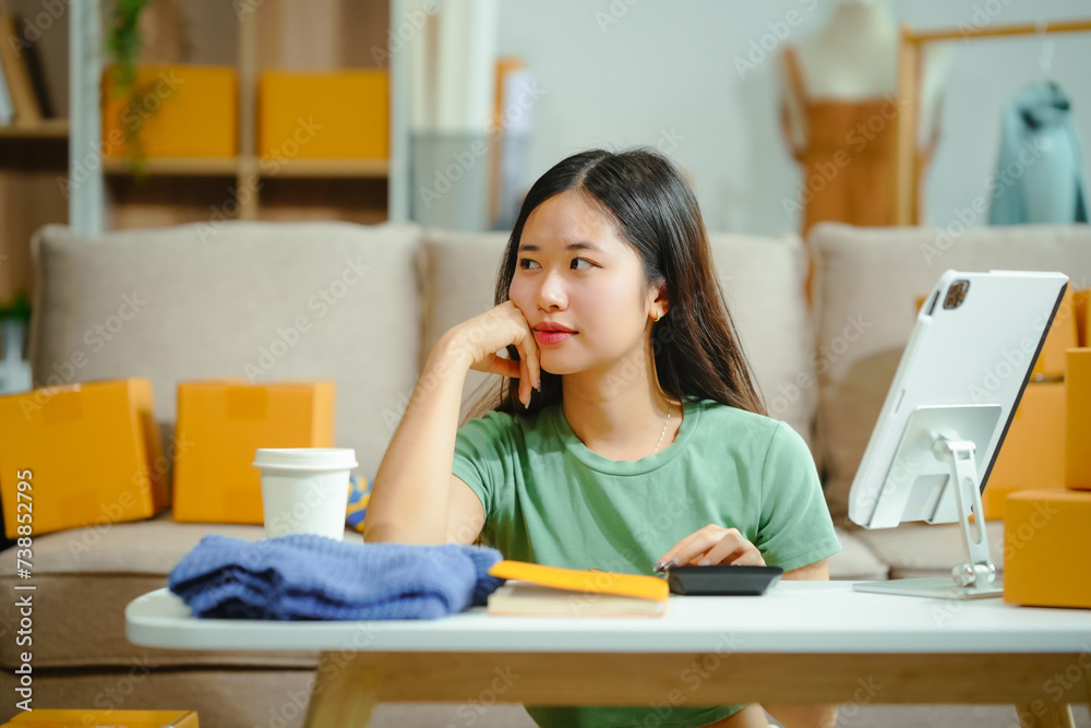 young Asian SME owner of a clothing store faces stress and sadness due ...