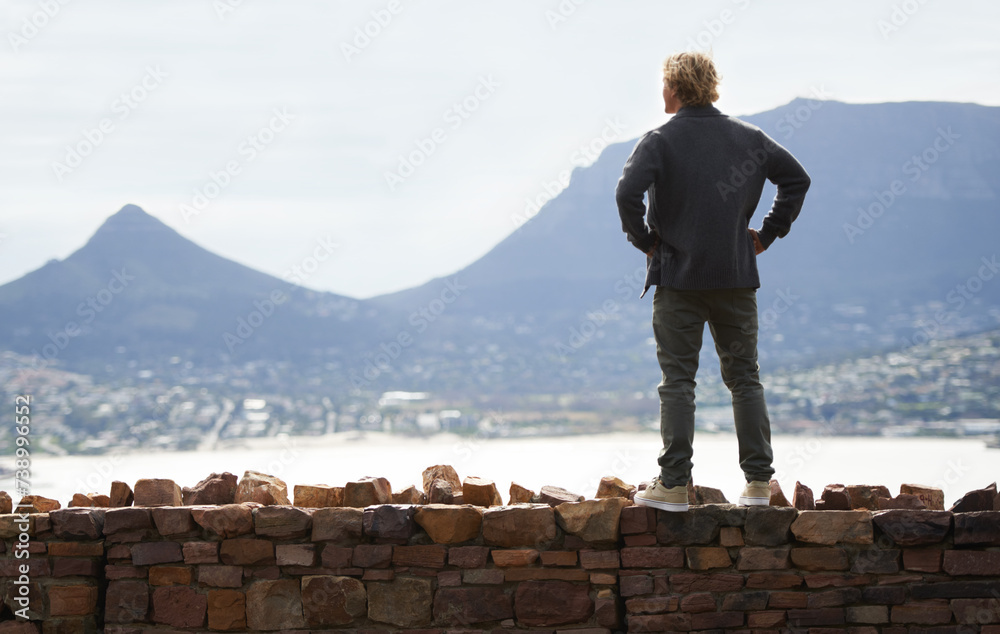 Man, watching mountains and thinking of adventure ideas and inspiration ...