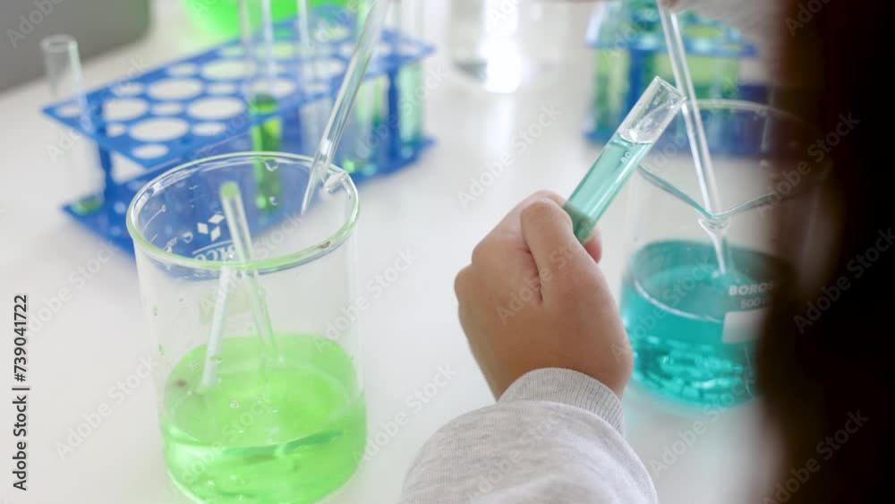Diverse group of students happy experiments with test tubes in science ...