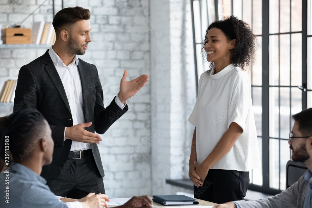 Shy company worker receiving positive feedback from satisfied CEO ...