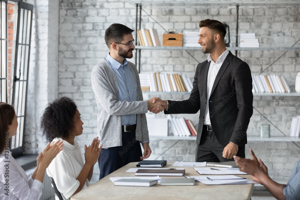 Smiling executive of successful multinational company shaking hands ...