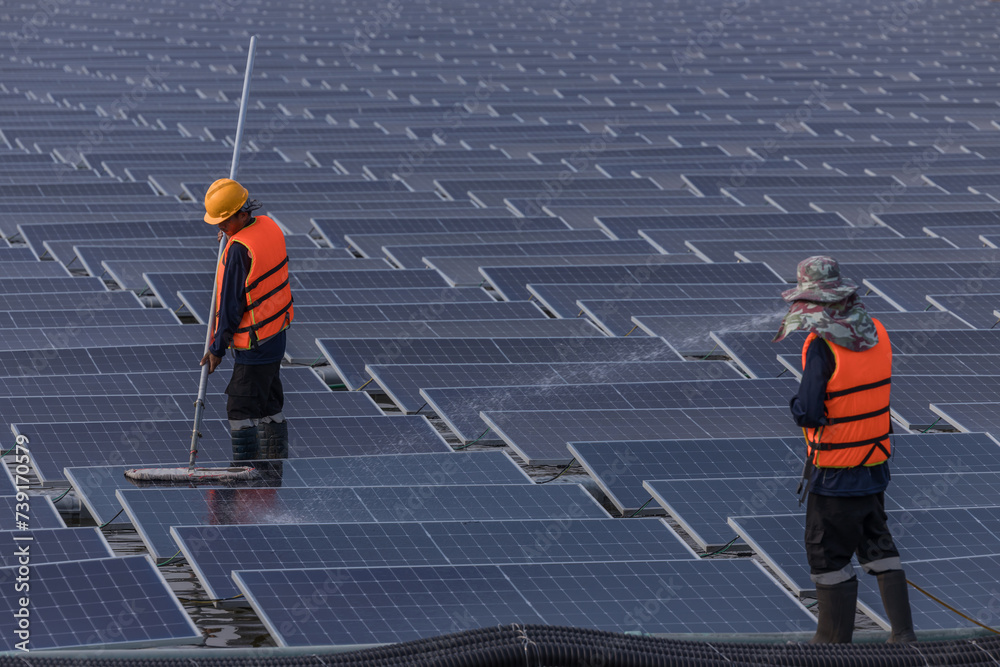Worker Cleaning floating solar panels or solar cell Platform system on ...