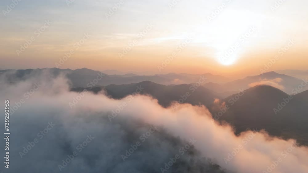 Morning sunrise over mist covered mountains with layers of fog nestled ...