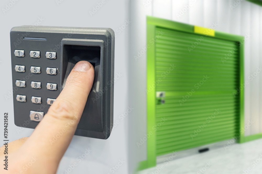 Electronic lock for entering warehouse. Fingerprint scanner near green ...