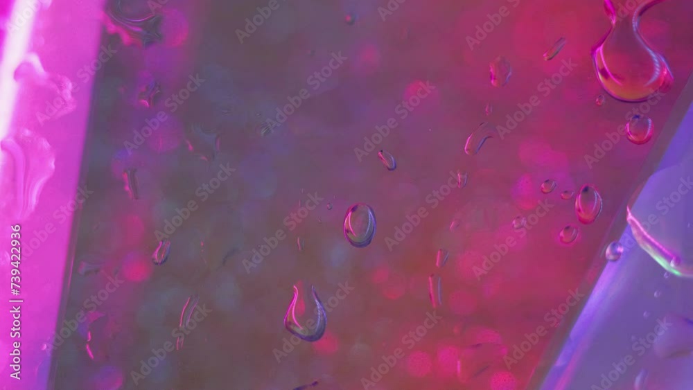 Neon water drop. Wet glass. Aqua splash. Defocused pink violet color ...