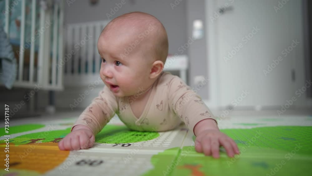 Baby lying on his stomach trying to keep head. Baby boy lifting head ...