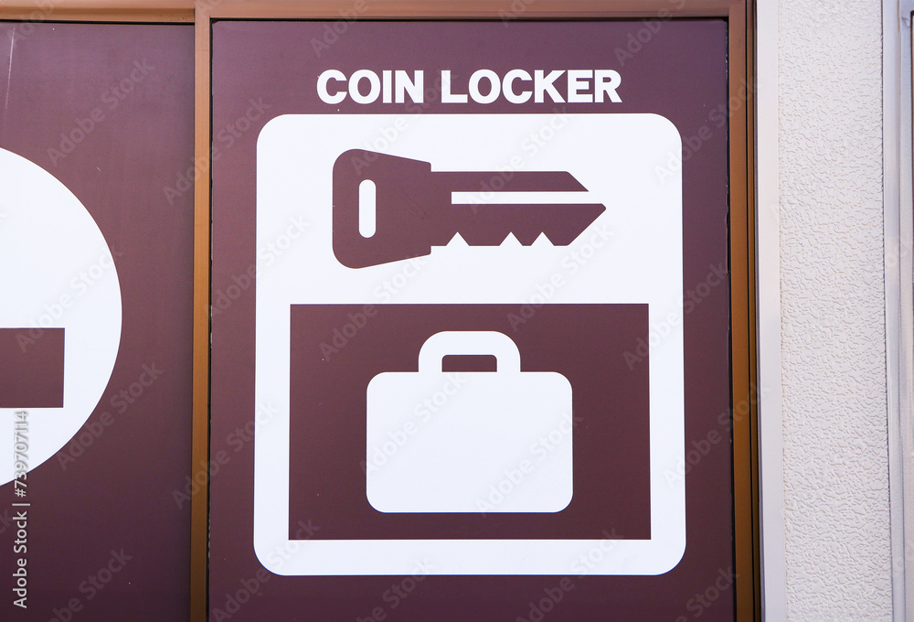 Sign or symbol COIN LOCKER BAG brown, white. Attached to the concrete ...