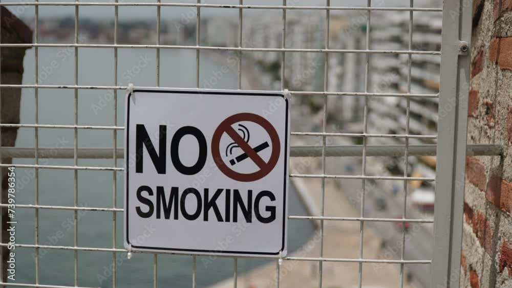 No smoking sign on fence overlooking resort embankment. Prohibition ...