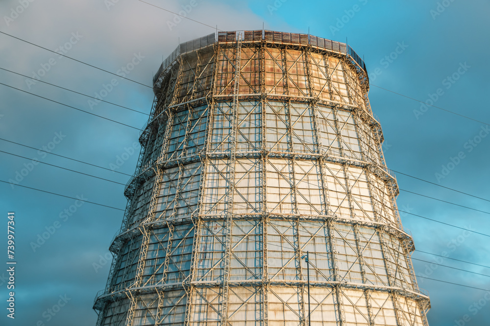 Large cooling towers of thermal power plants. White steam comes out of ...