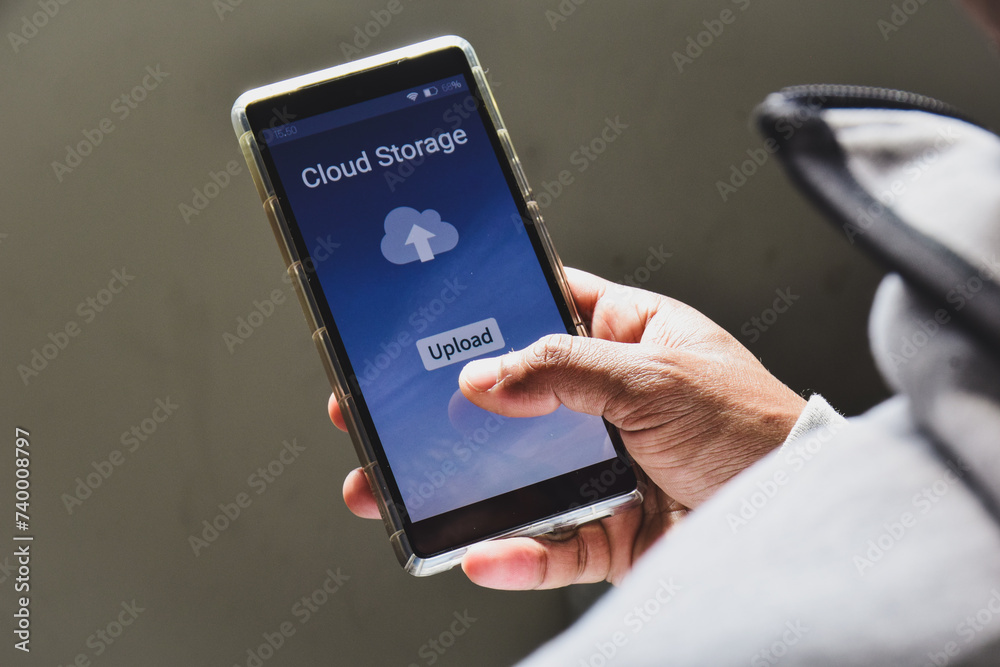Person using online file sharing storage service to upload and backup ...
