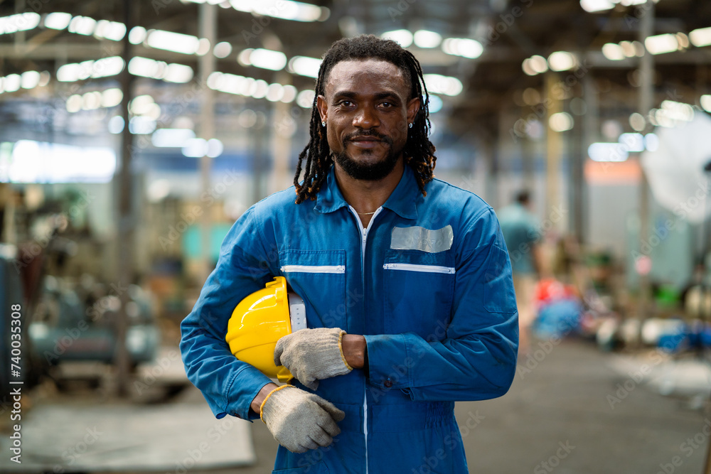 Portrait of a black male mechanical engineer working at a metal lathe ...